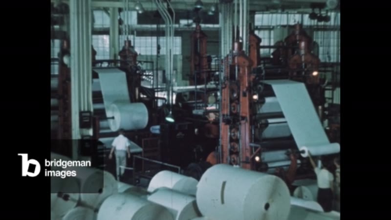 Image of 1960s: A printing press room with operators. People wheel a