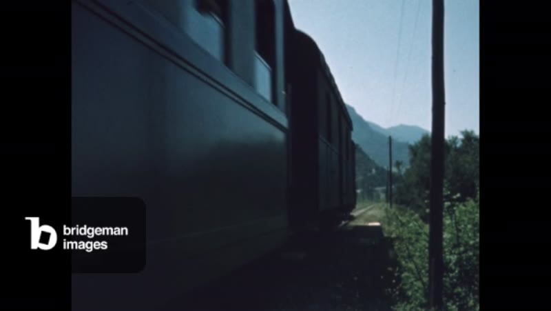 Image of 1960s: Steam-powered passenger train moves along tracks in ...