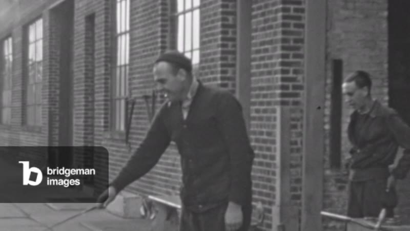 Image of Two Men Standing Outside a Brick Building in New York