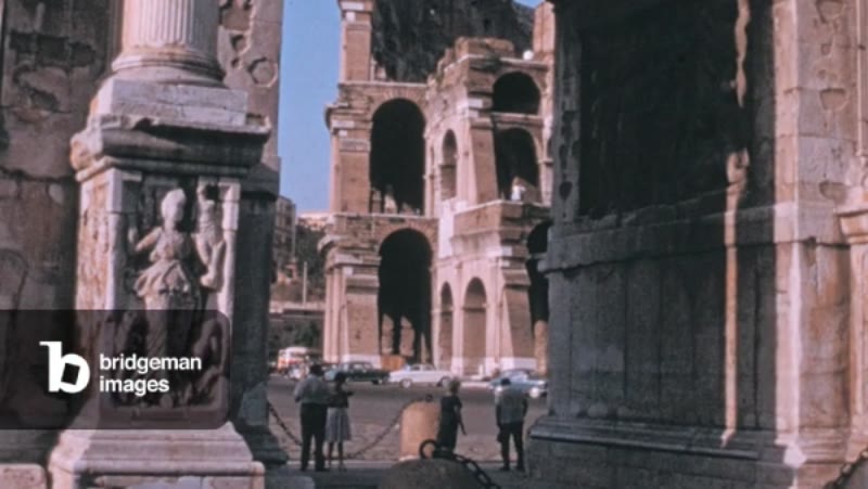 Image of Tourists Walk Under the Triumphal Arch of Constantine in Rome