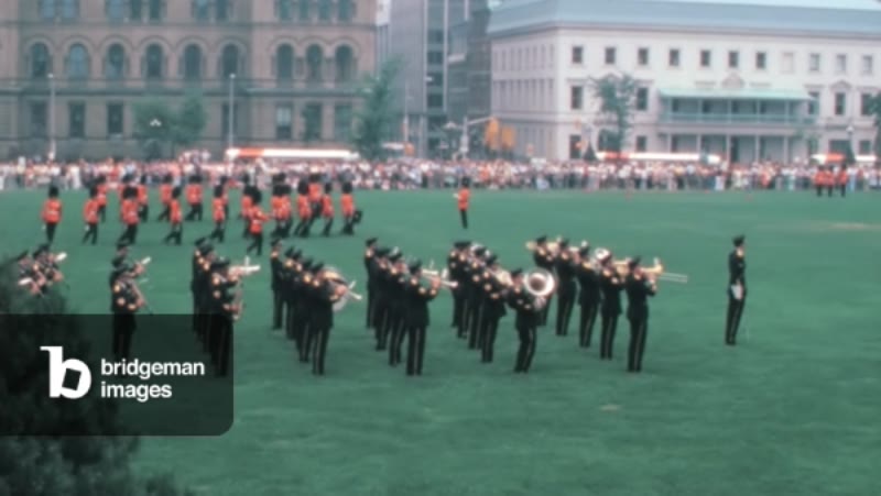Image of Group of soldiers marching to sound of music played by