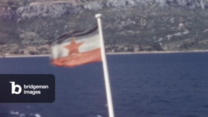 Image of Yugoslav Flag with Communist Red Star Waving from Ship in